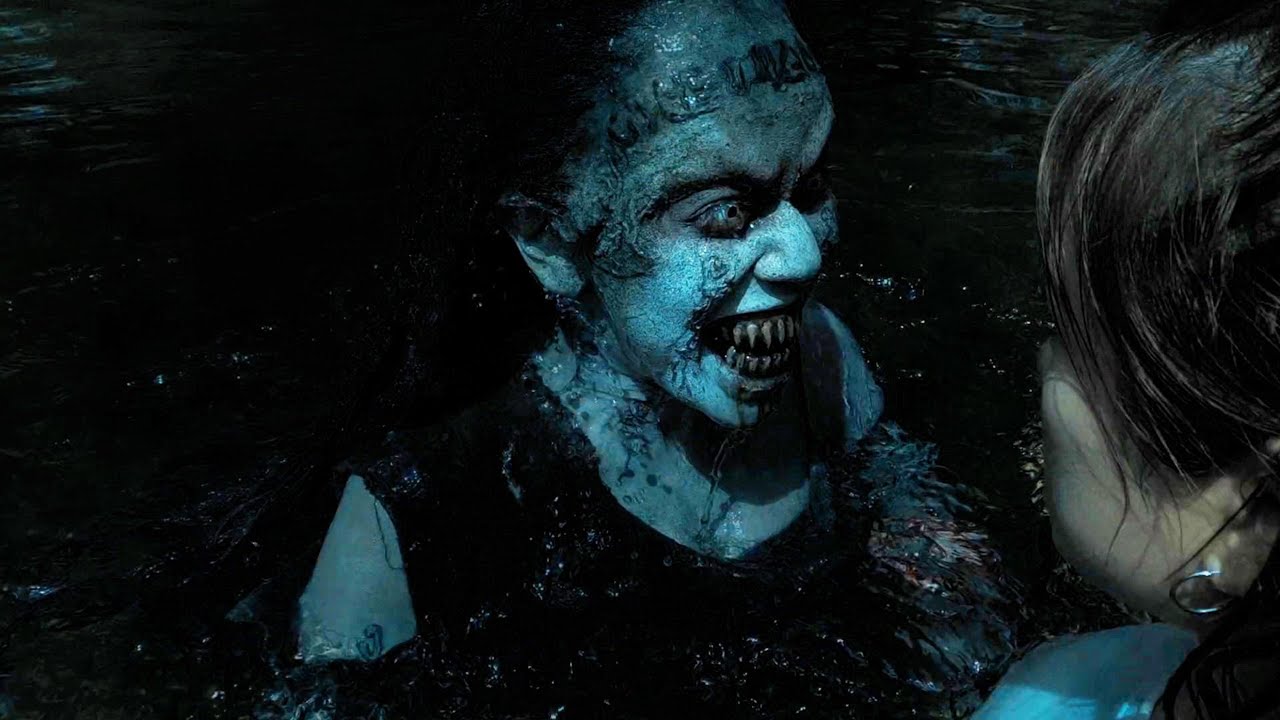 Creepy blue skinned water demon emerges from the lake to drag a young ...