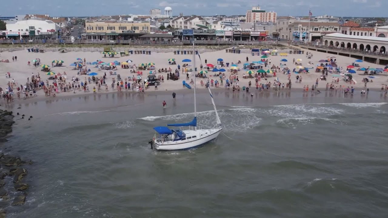 VIDEO | Sailboat stranded on Jersey Shore beach after captain steps ...