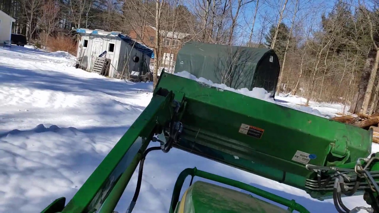Stacking snow with the front end loader on the backhoe - YouTube