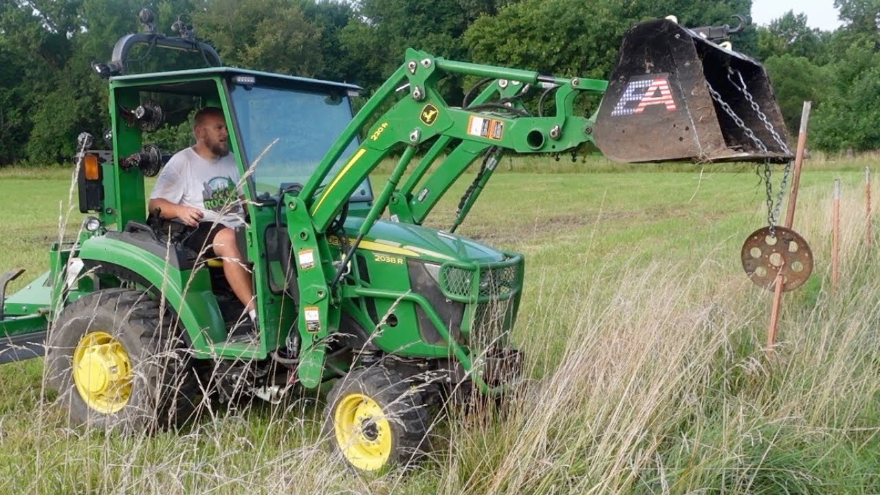 Removing Barbed Wire Fence and Pulling Fence Post with a Flywheel - YouTube