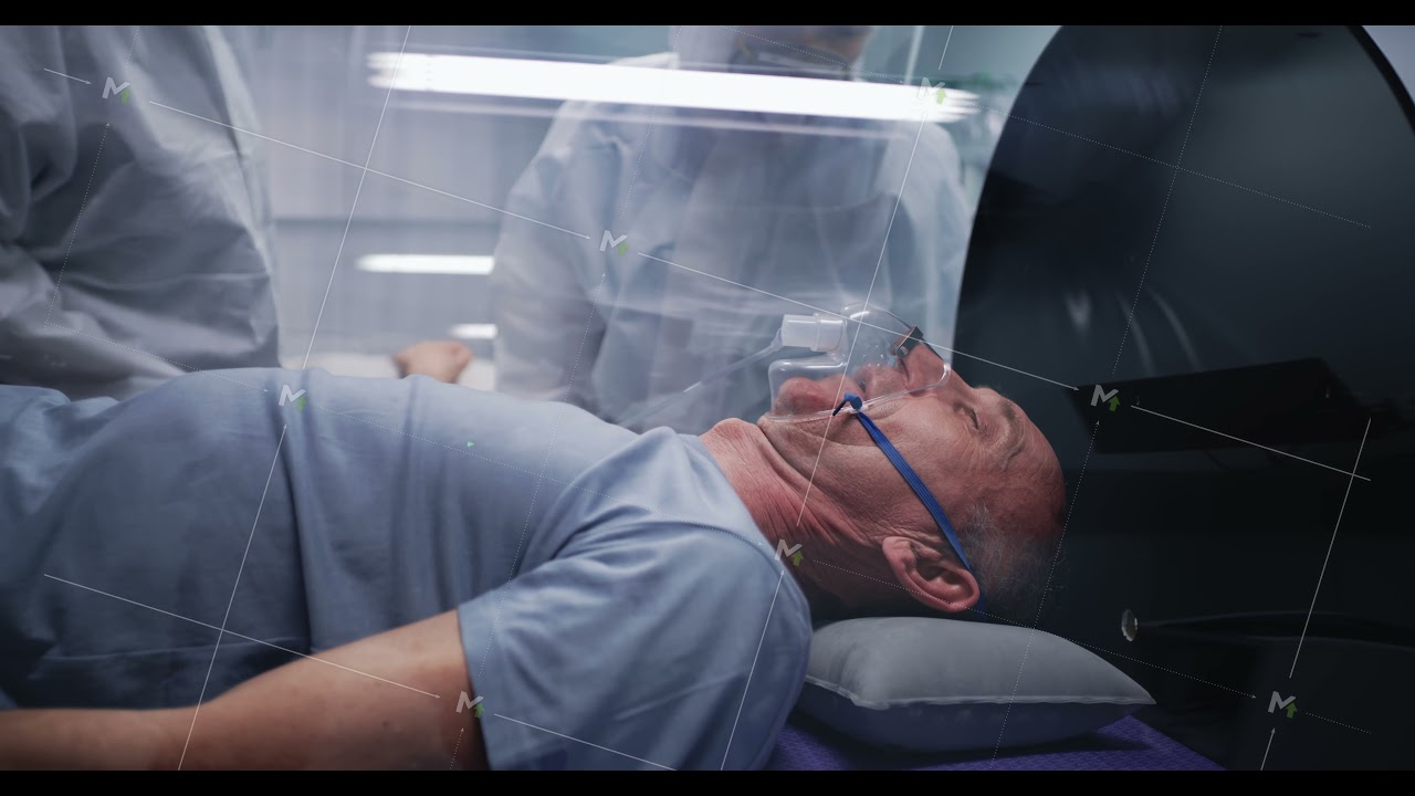 Medical practitioners speaking near heavily breathing aged patient ...