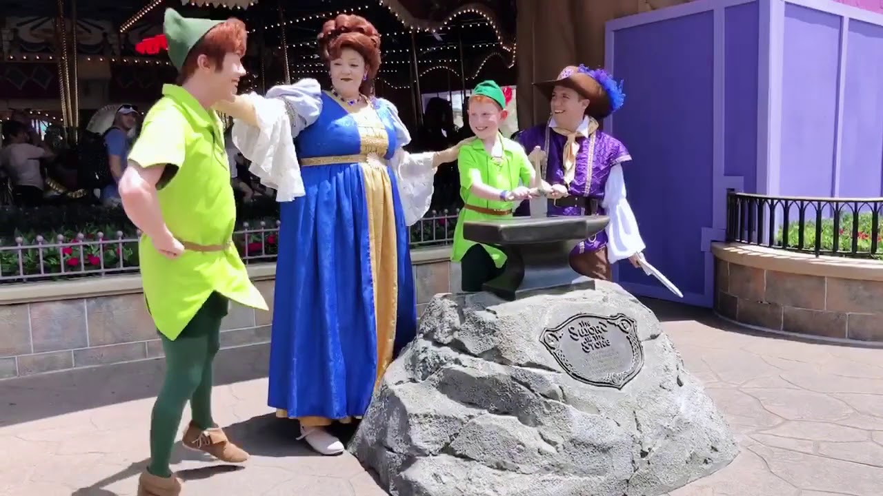 Little Peter Pan pulls the Sword from the Stone, with help from Peter ...
