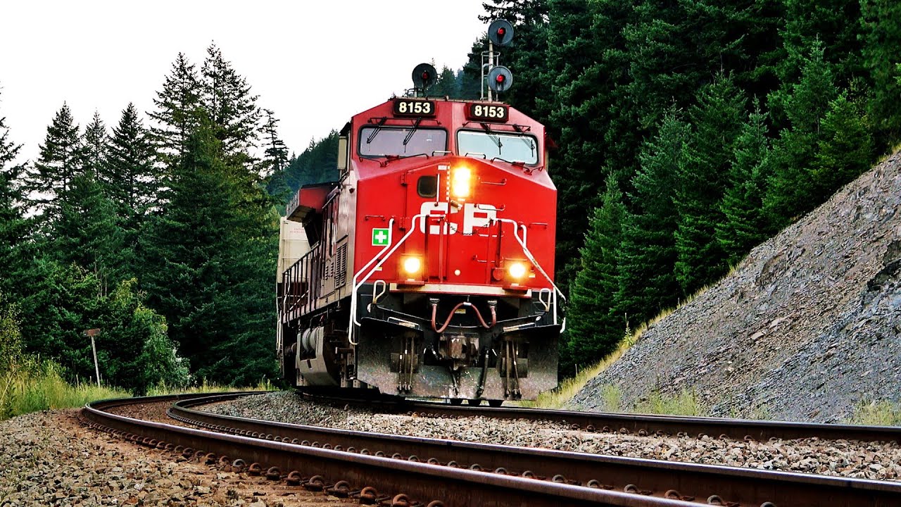 CPKC Grain Train Curves Under Overhead Signals Onto The North Track On ...