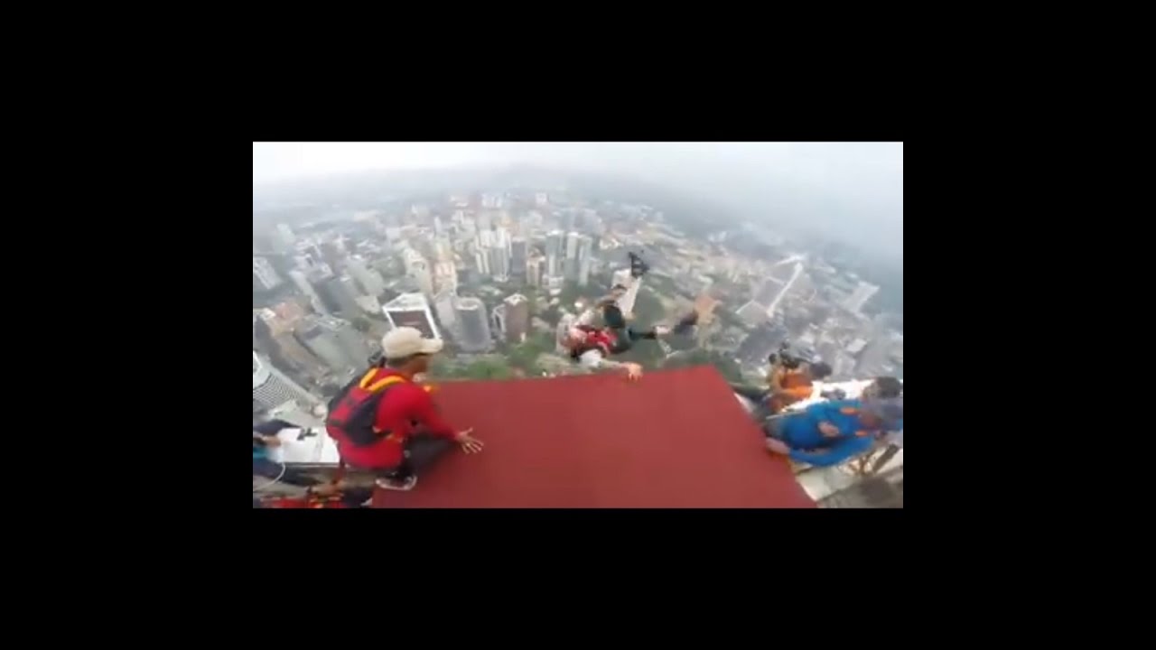 Guy accidently falls off a skyscraper - YouTube