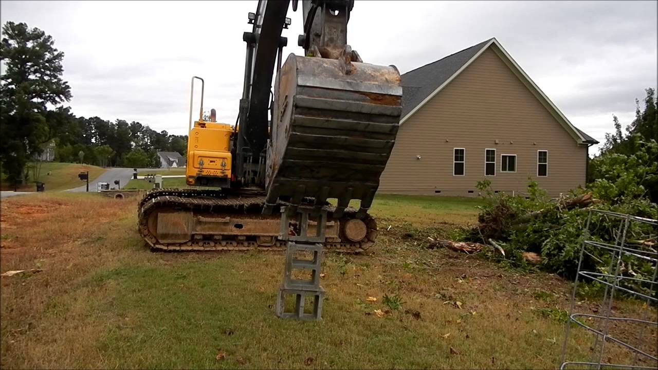Excavator Stacking Concrete Blocks - YouTube