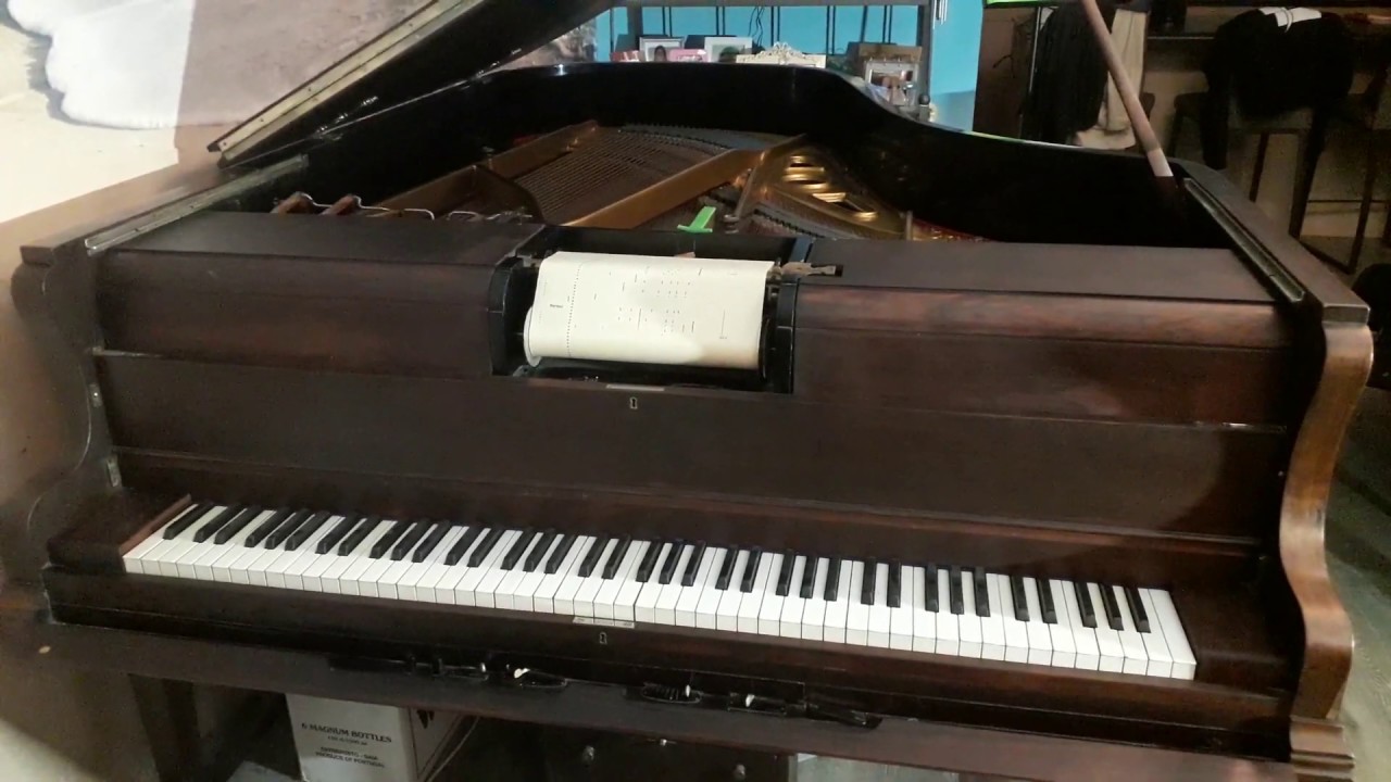 Medium grand piano with oak case and 50 music rolls. - YouTube