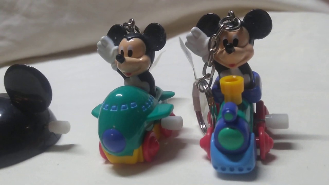 Vintage wind-up keychains Mickey Mouse in a plane and a train racing ...