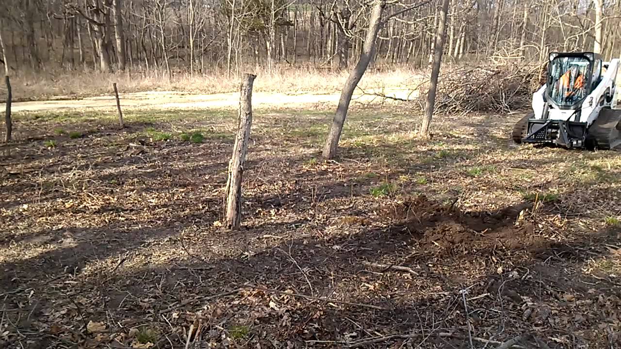 Bobcat T750 with tree puller - YouTube