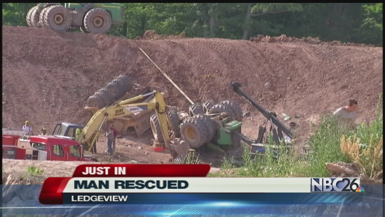 Man rescued after being trapped under tractor - YouTube
