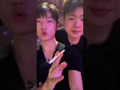 Handsome boys smoking and spitting on the street