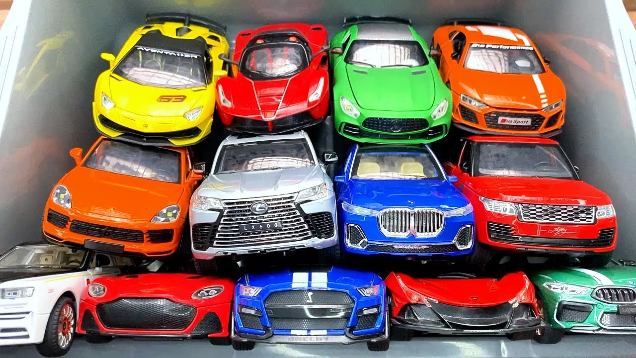 Box full of various miniature cars Peugeot, Jaguar, Pagani, Hyundai ...