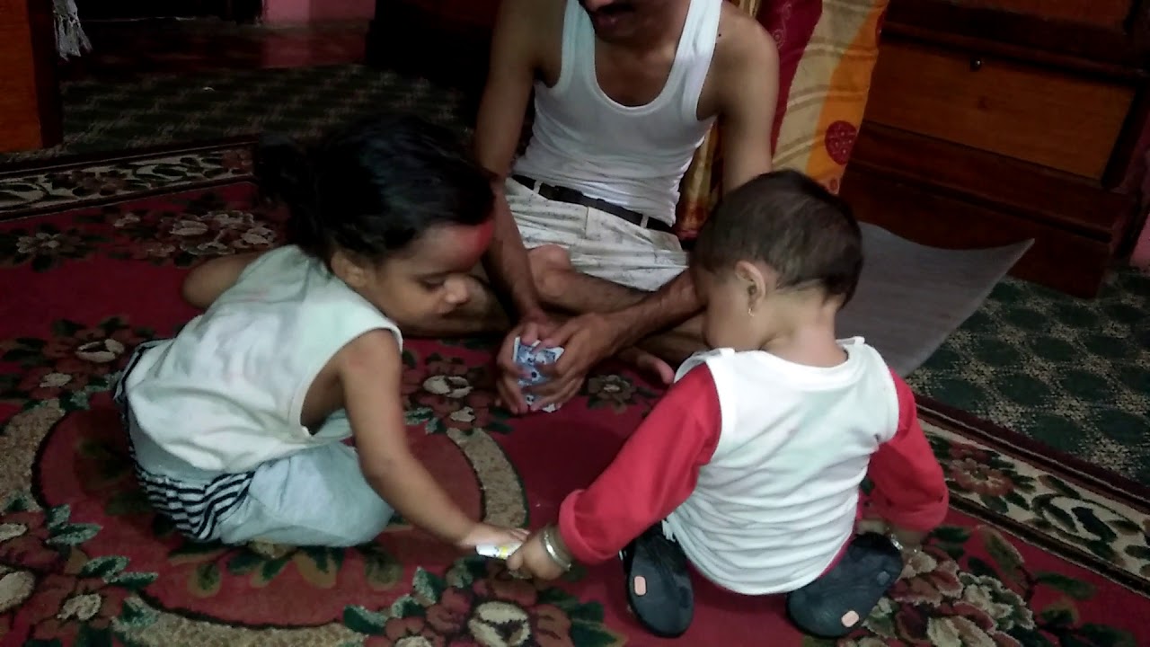 Two baby playing card at dashain - YouTube
