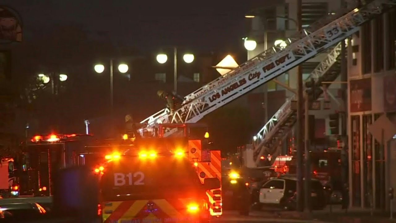 LA blaze: Firefighters at cordoned off building | AFP - YouTube