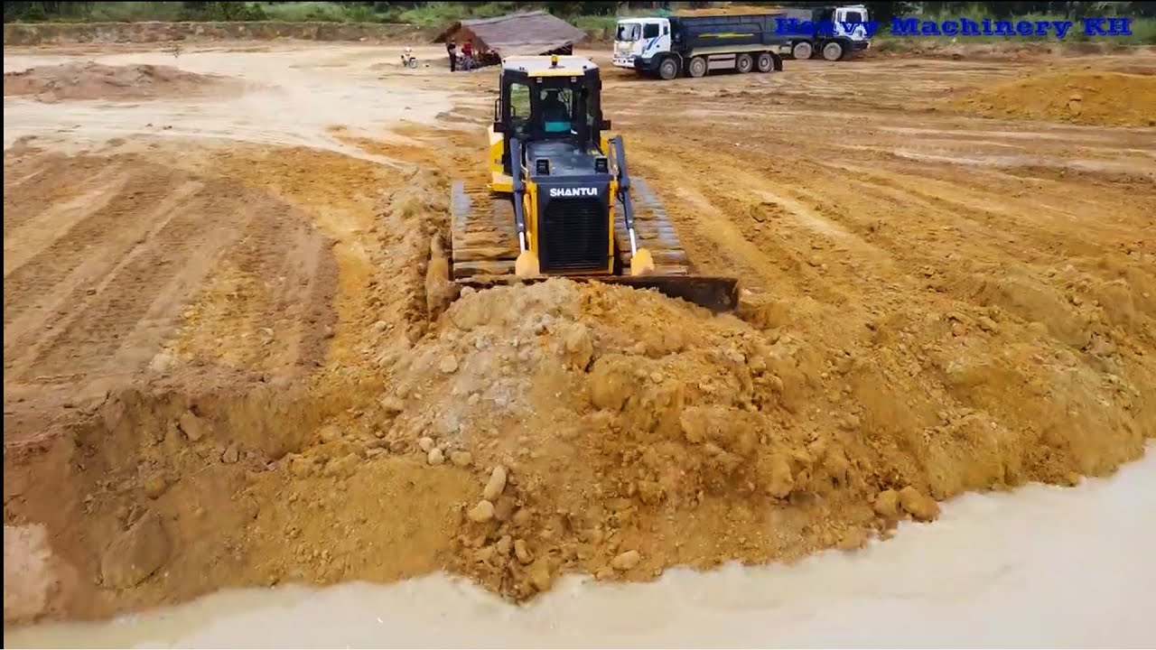New Bulldozer Working Hard Pushing Dirt Back Fill - Dump Truck Driving ...