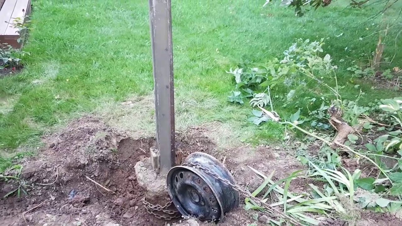 Pulling a 4x4 wood fencepost with concrete using a come along - YouTube