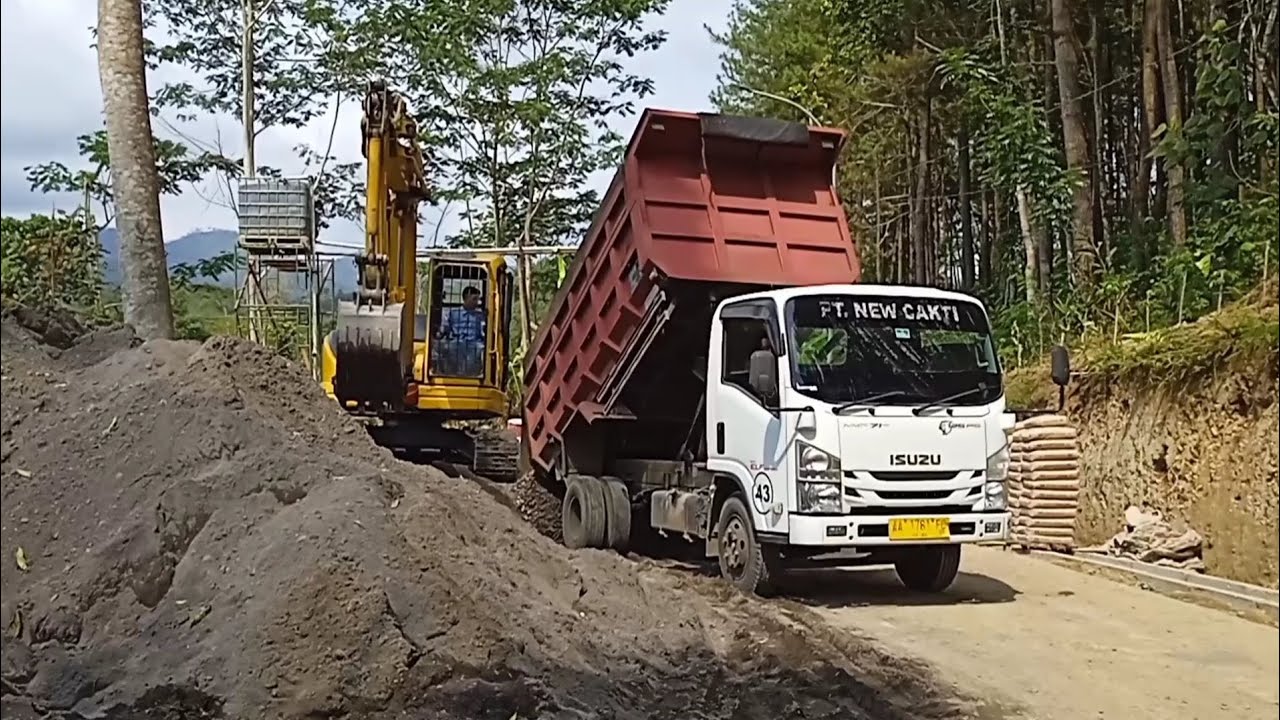 Dump truck excavator working at concrete mixing location. - YouTube