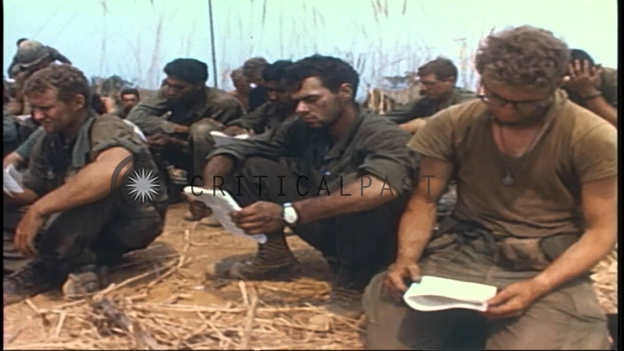 A catholic chaplain conducts the Mass and soldiers receive communion in ...