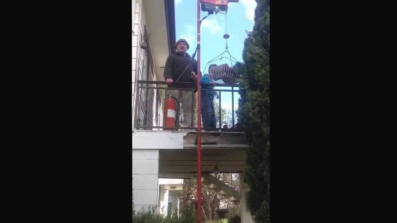 Hoist lifting firewood or shopping from ground up to 2 storey house ...