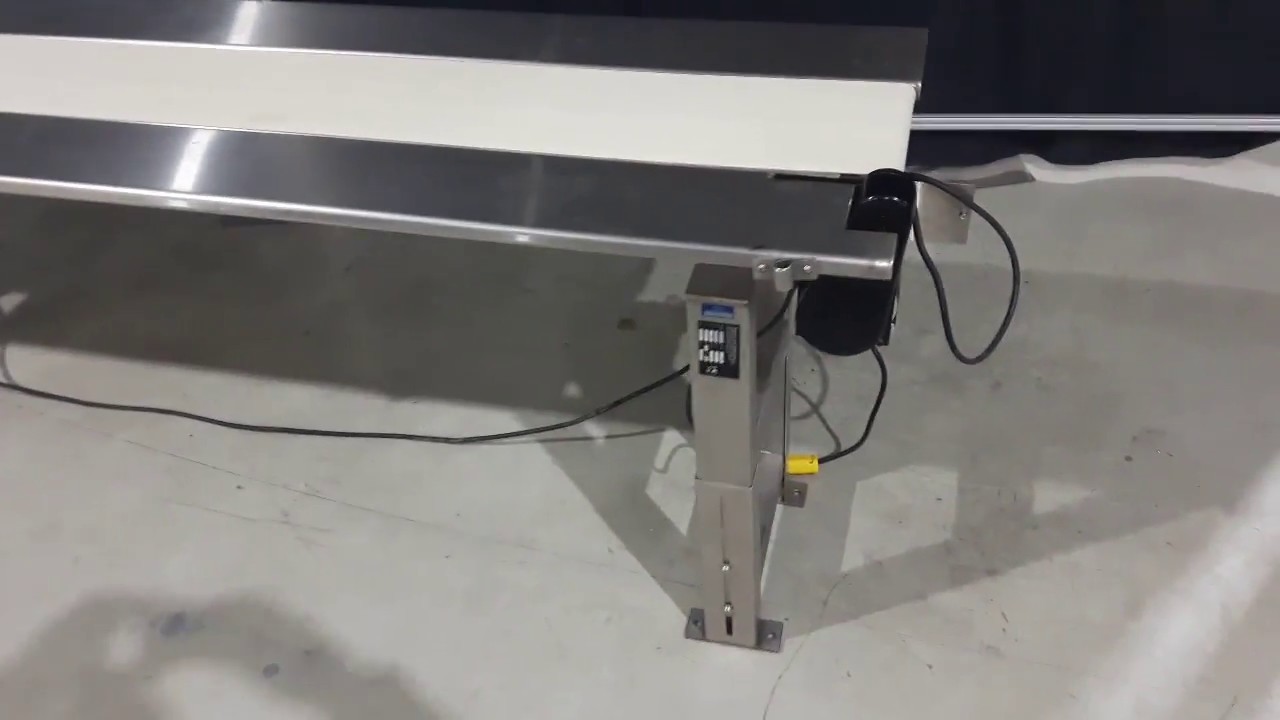 Dorner stainless steel belt conveyor with side packing tables - YouTube