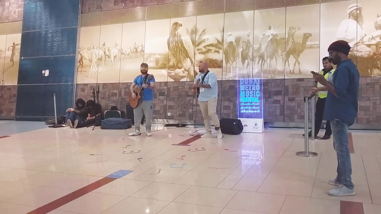 Street performer playing guitar in Dubai metro station. - YouTube
