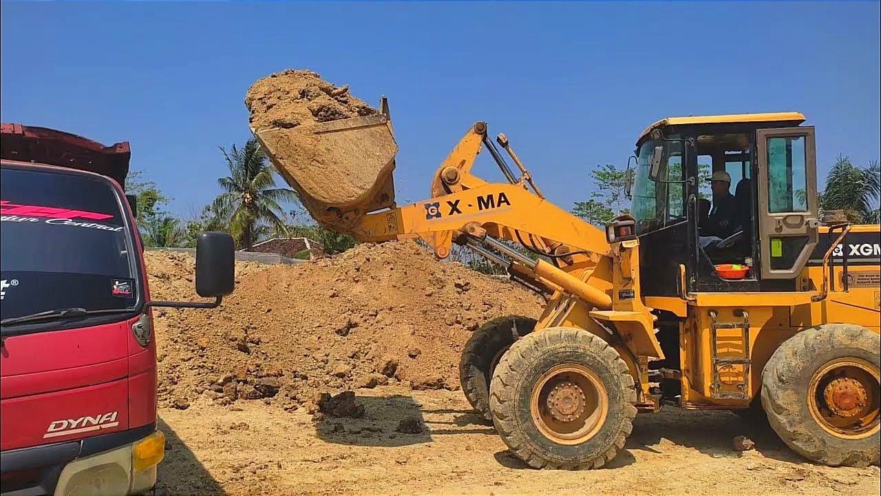 Wheel Loaders and Dump Trucks Work at Construction Sites Dredging and ...