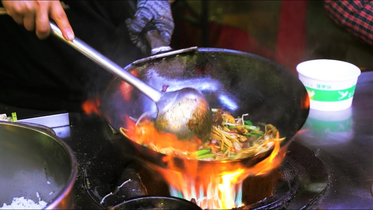 Chinese Street Food -Fried noodles with egg fried rice, fried sausages ...