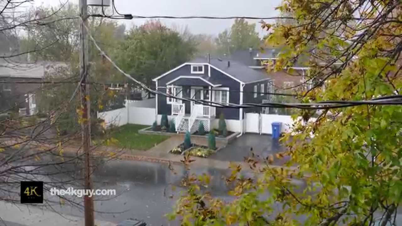 4K UHD - Hail and rain storm with wind blowing in residential ...