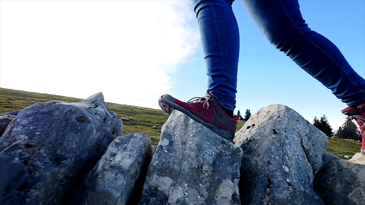 person hiking over rock mountain stones close up of walking feet nature ...