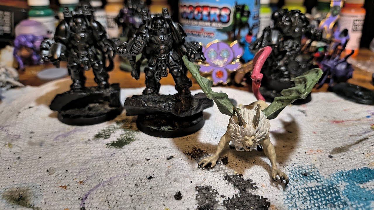 Priming and painting some Warhammer and DnD minis late at night because ...