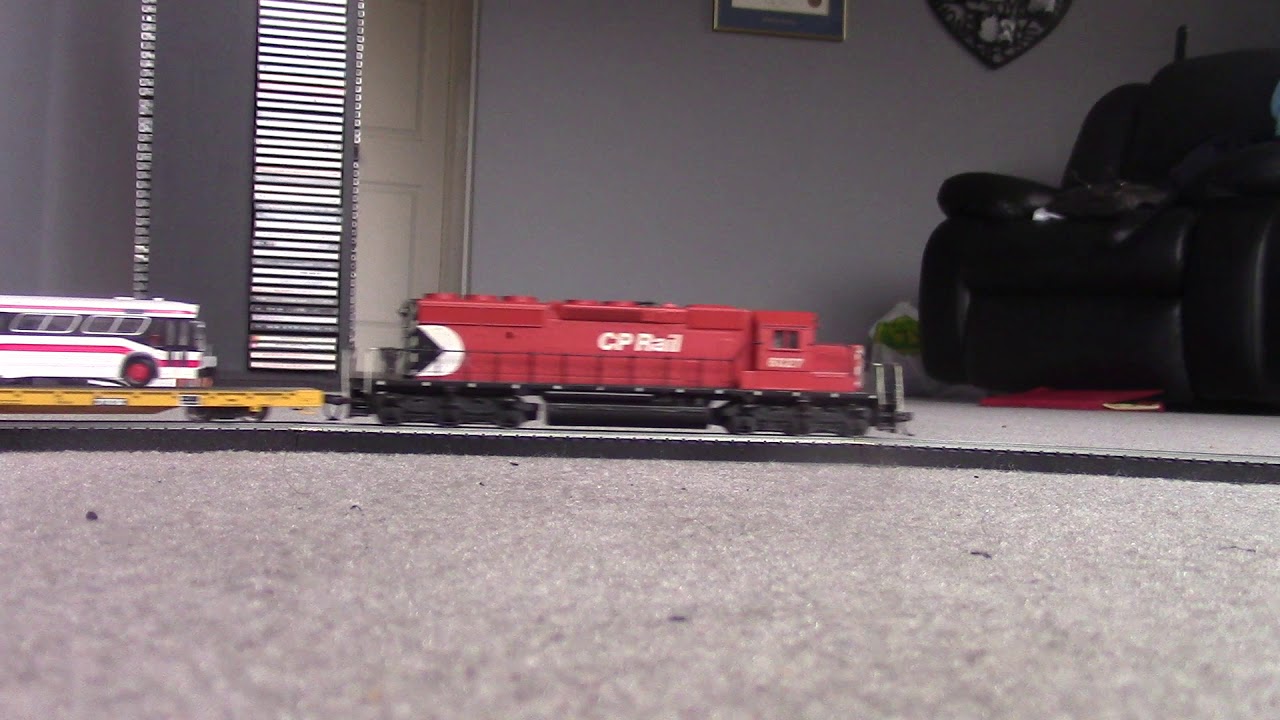 CP HO scale train carrying a TTC GM new look fishbowl bus and Ryu ...