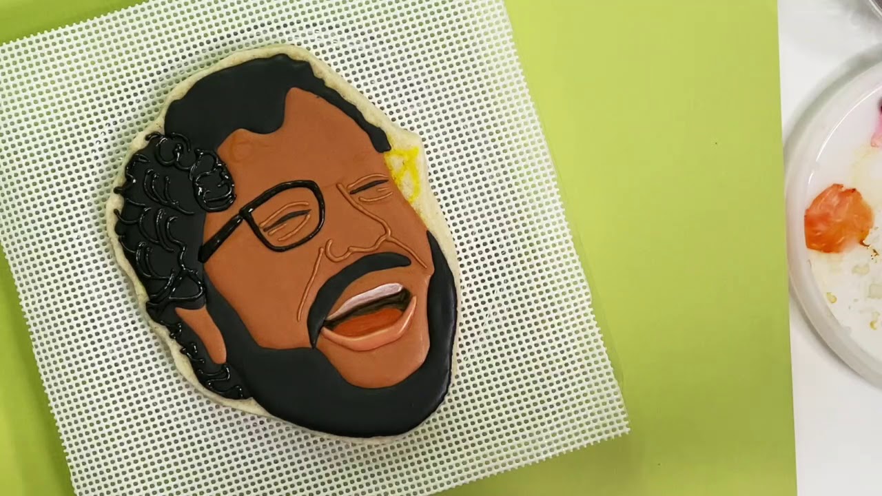 Jasmine Cho decorating a portrait cookie of comedian, writer, and ...