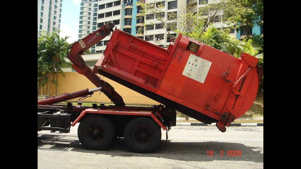 Truck Hauling A Garbage Compactor - YouTube