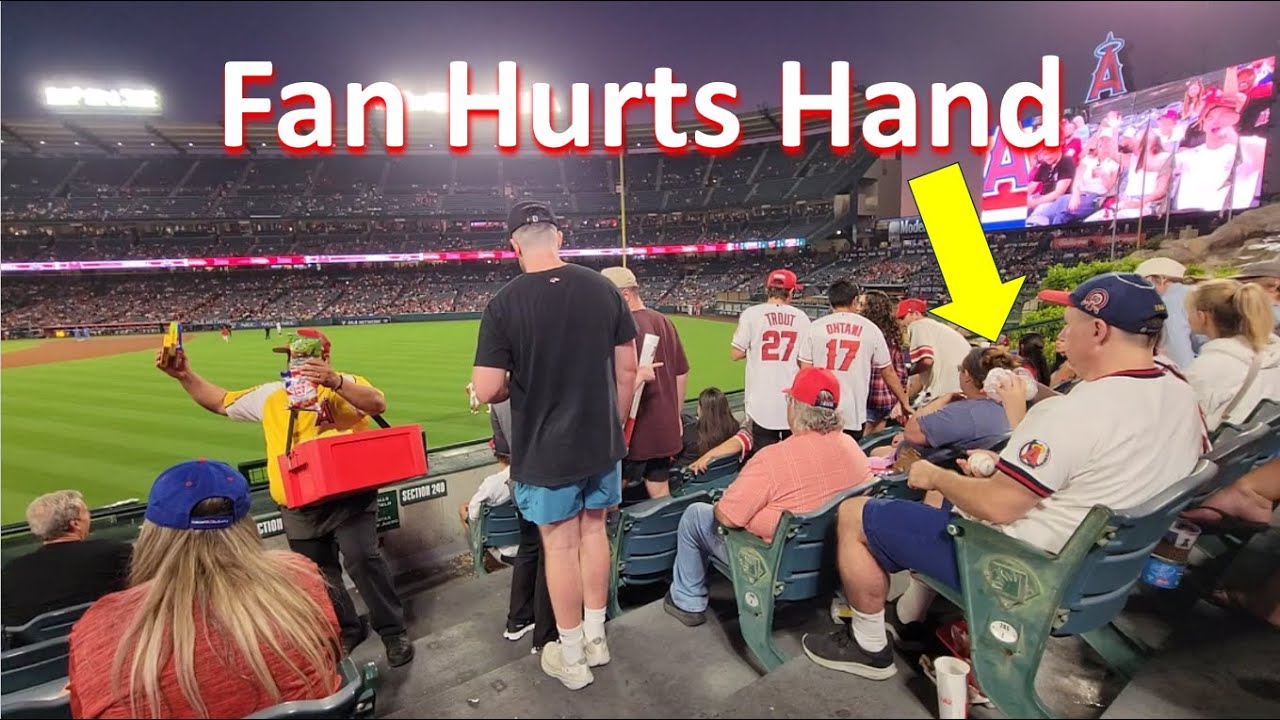 Fan Hurts Hand Catching a Baseball Barehanded at Angel Stadium - YouTube