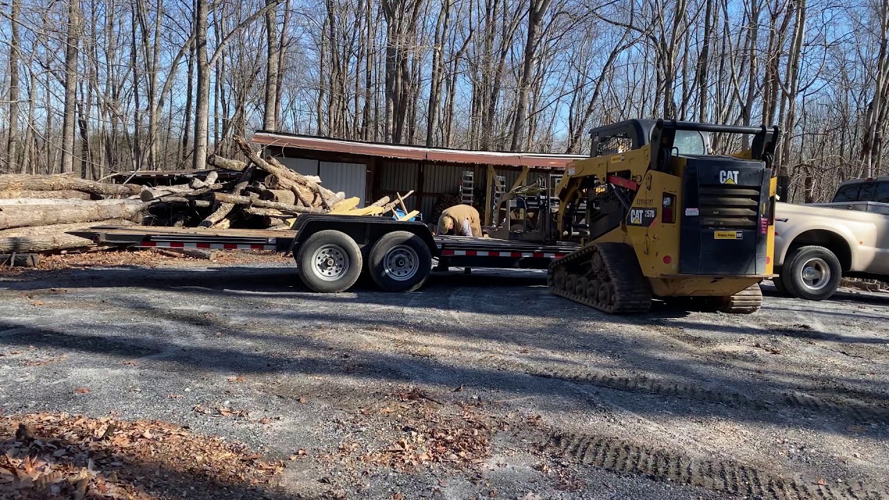 2) Cat skidsteer loading/unloading from gooseneck tilt trailer - YouTube