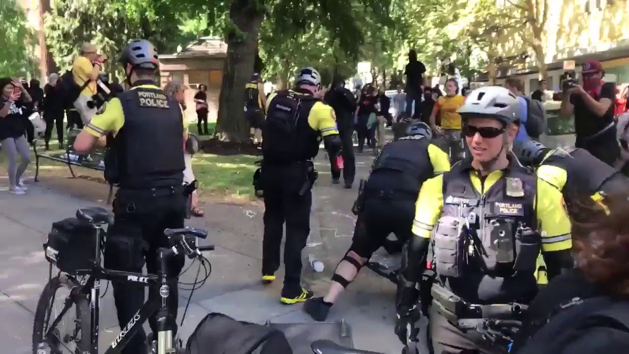 Video: Protesters throwing objects at police during protest - YouTube