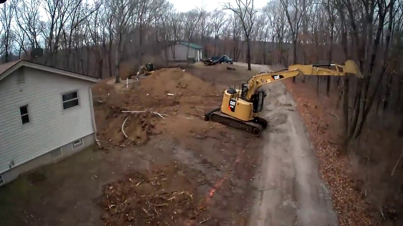 Pushing over trees with the CAT 315 - YouTube