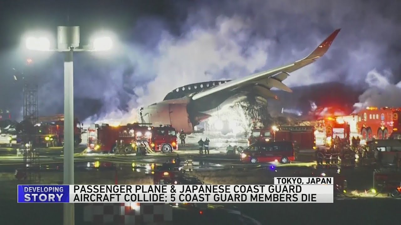 Plane burns on runway at Tokyo airport after collision, five dead - YouTube