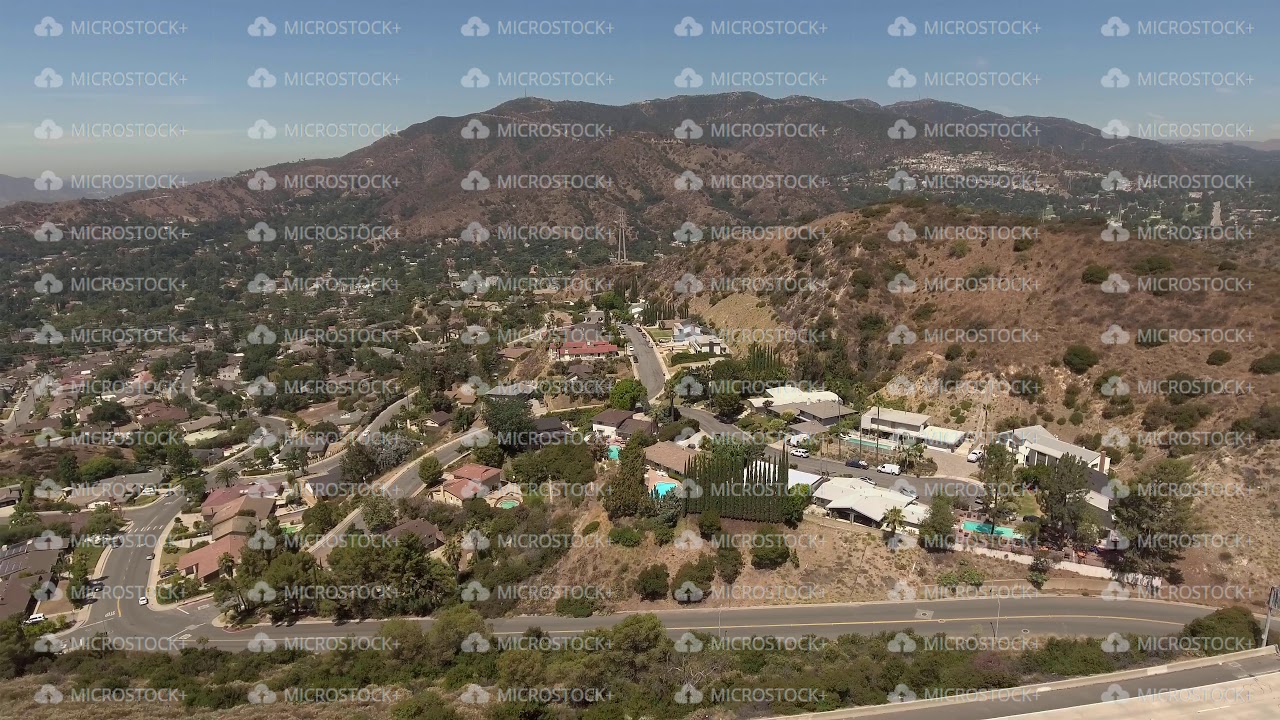 Aerial shot of neighborhoods, roads and mountains in Glendale ...