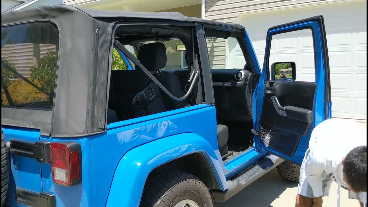Flipping down the soft top on a 2-door Jeep Wrangler JK (2007-2018 ...