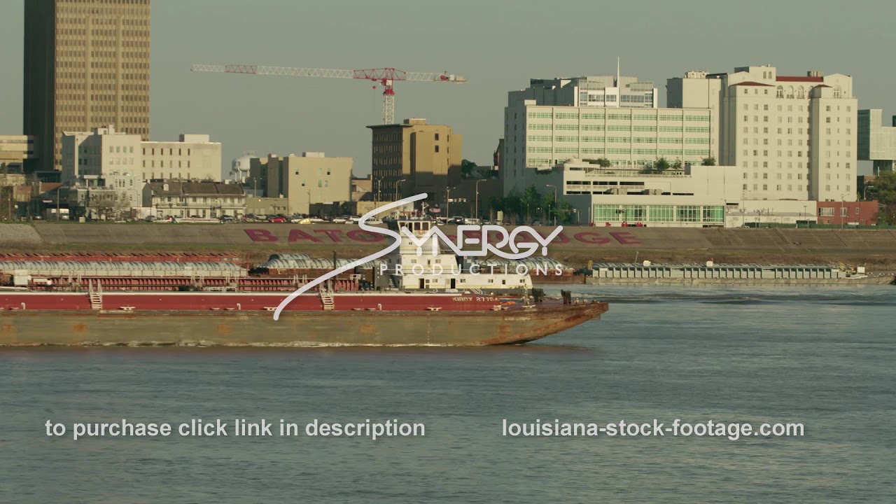 1942 baton rouge skyline with barges motoring by Mississippi River ...