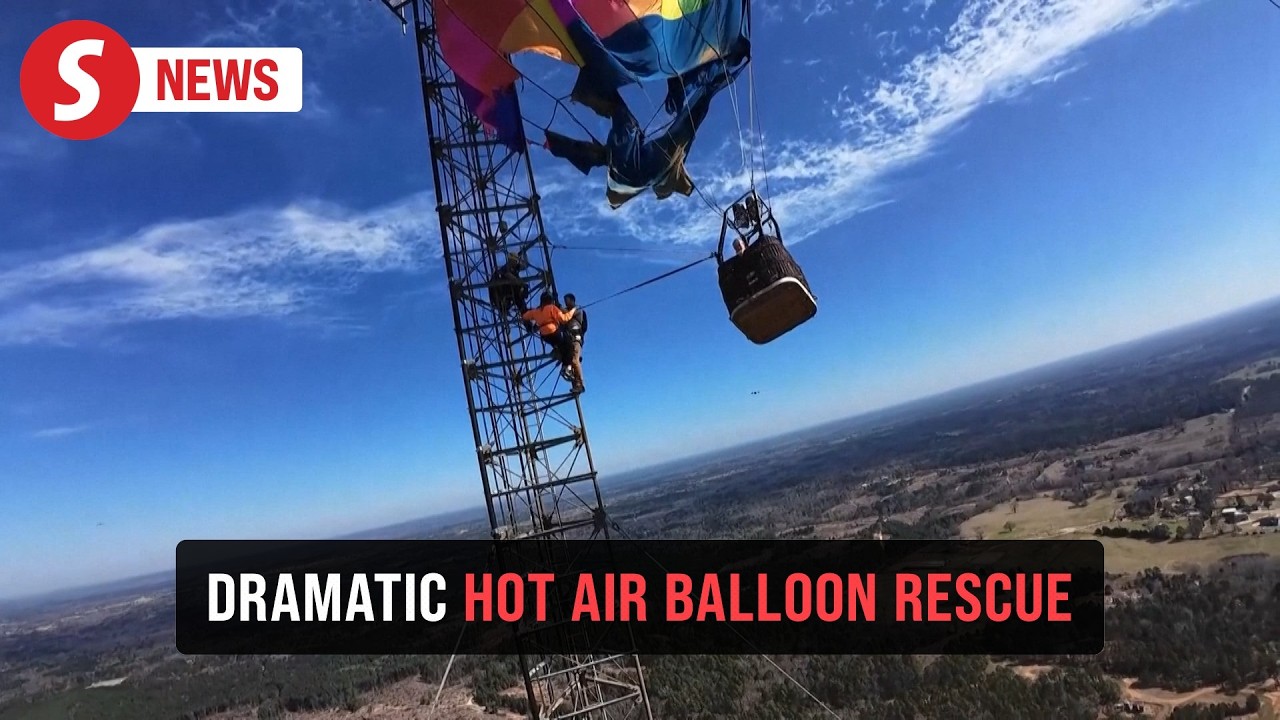 Two rescued from hot air balloon stuck over 280 meters in the air - YouTube