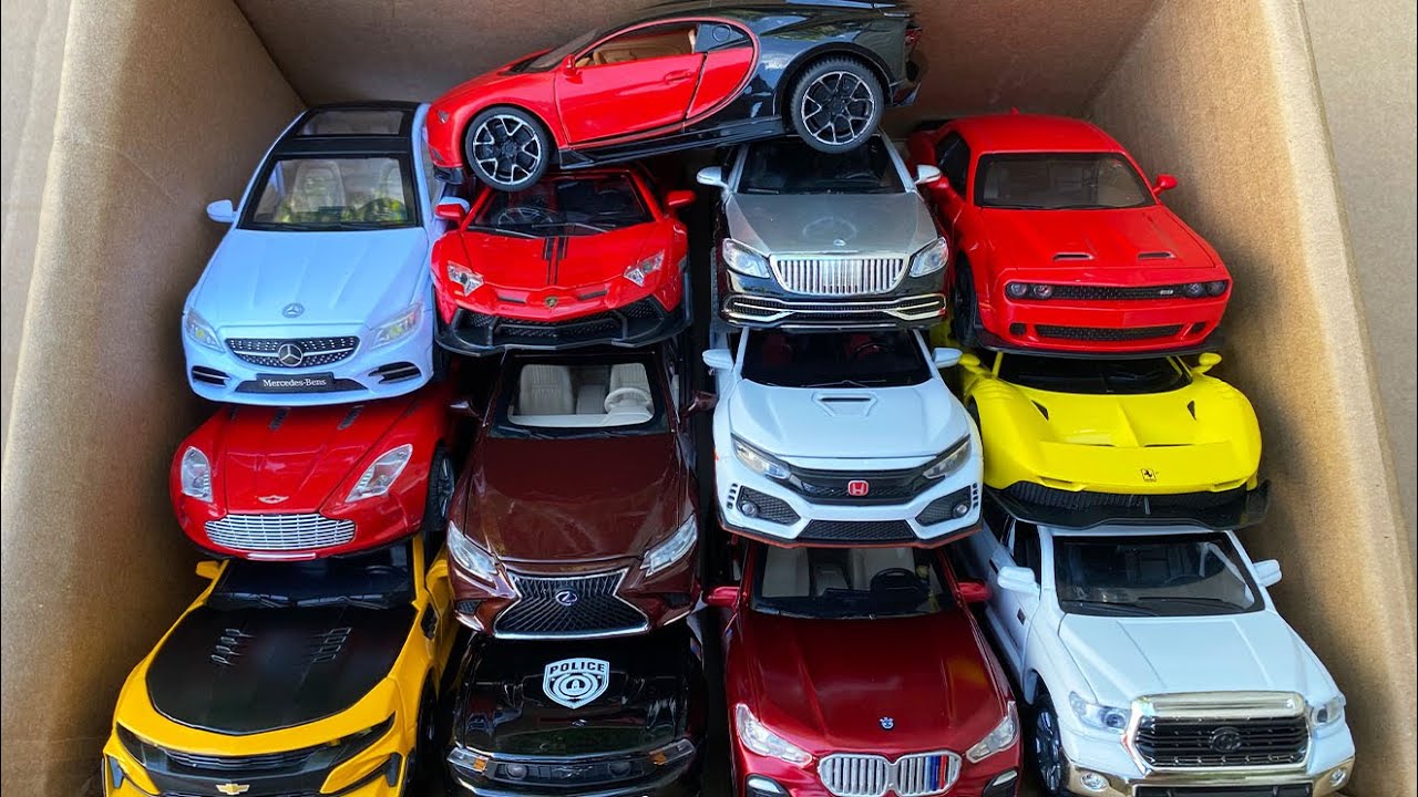 Box full of diecast model cars, bugatti, mercedes benz, dodge challenge ...