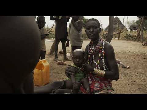 Toposa tribe woman breastfeeding her baby, Namorunyang State, Kapoeta, South Sudan