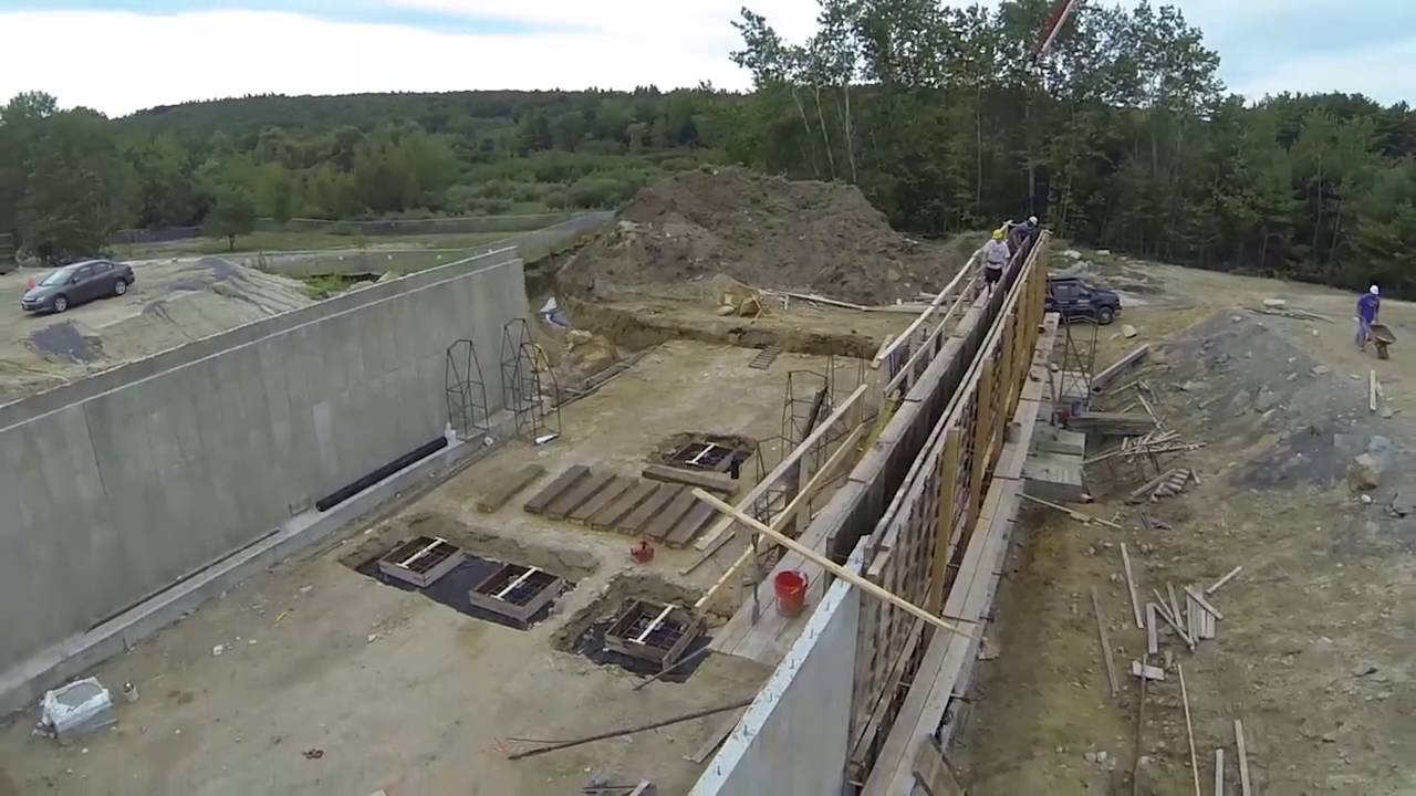 Drone video footage of concrete foundation pour - YouTube