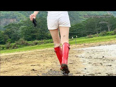 311期Barefoot, wearing boat socks and red rain boots, stuck in the mud.