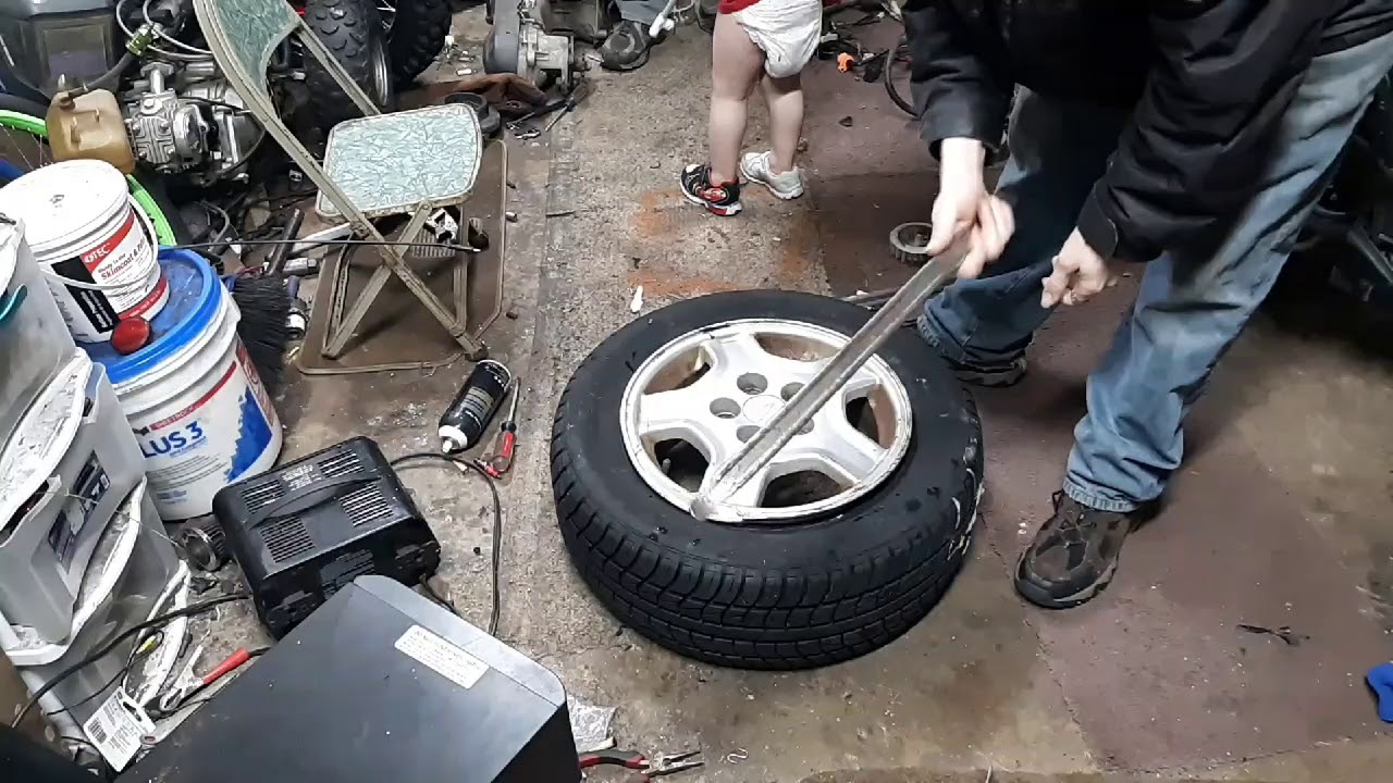 Breaking down a car tire by hand - YouTube