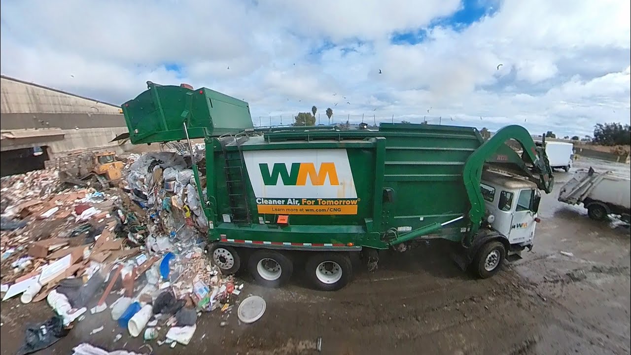 Garbage trucks dumping at transfer station - YouTube