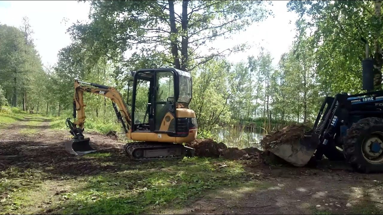 Moving dirt with a mini excavator and tractor. - YouTube
