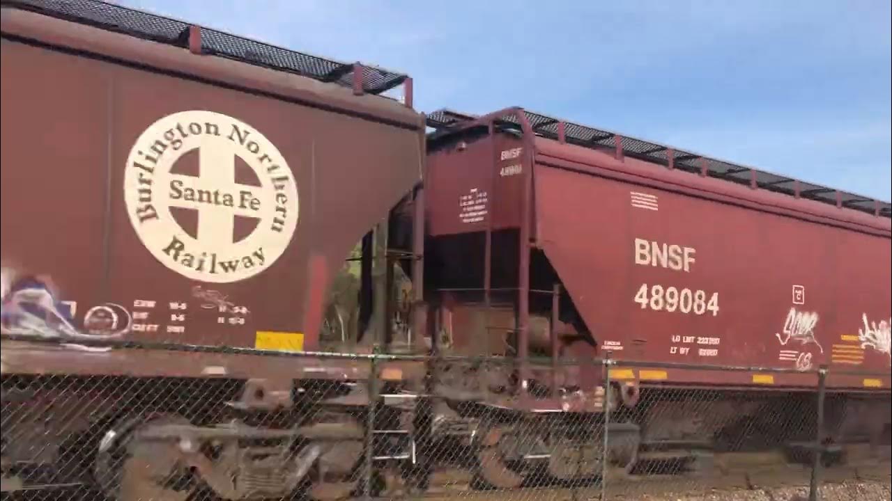 BNSF eastbound grain train with a horn show dash 9 a CSX sticker unit dash 9 and an SD70ACE ...