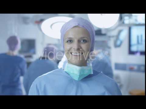 Positive and Smiling Nurse Taking off Surgical Mask after Successful ...